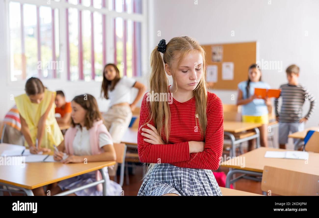 Girl alone in classroom sad hi-res stock photography and images - Alamy