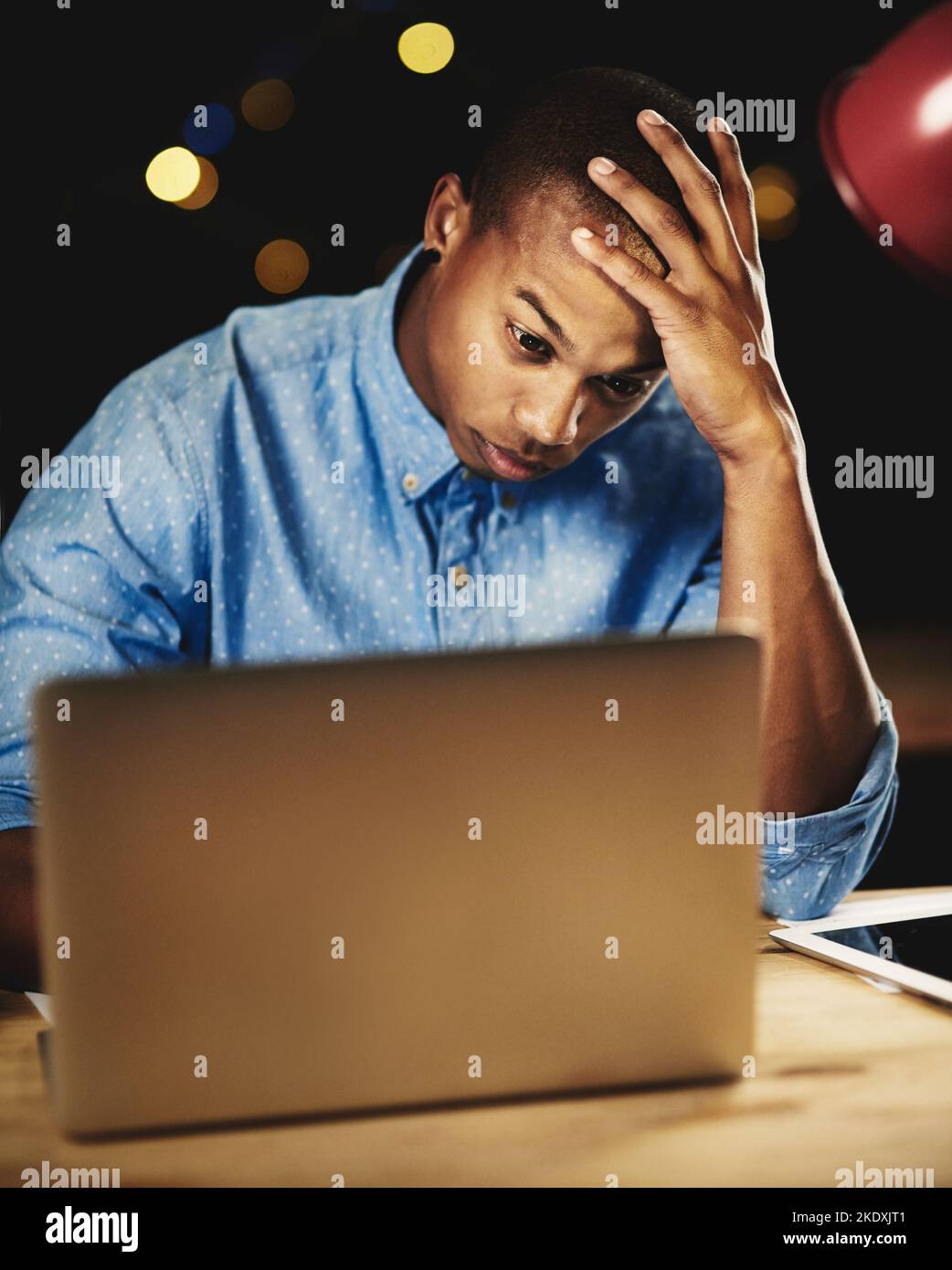 Hes got a deadline to meet. a young man looking stressed while working ...