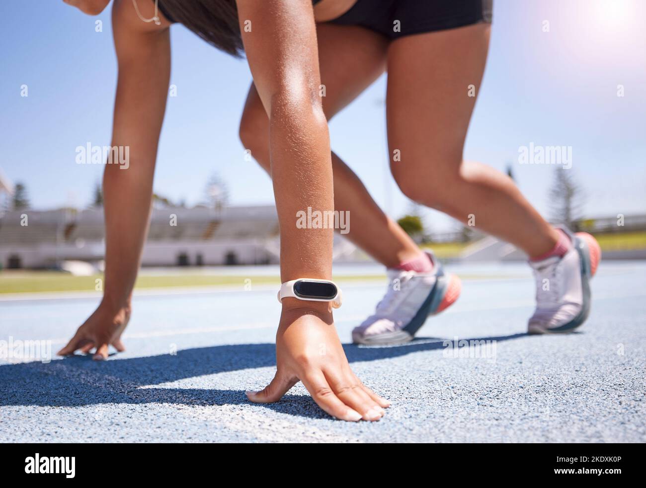 Hands, race and runner with a sports woman on track ready to start an ...