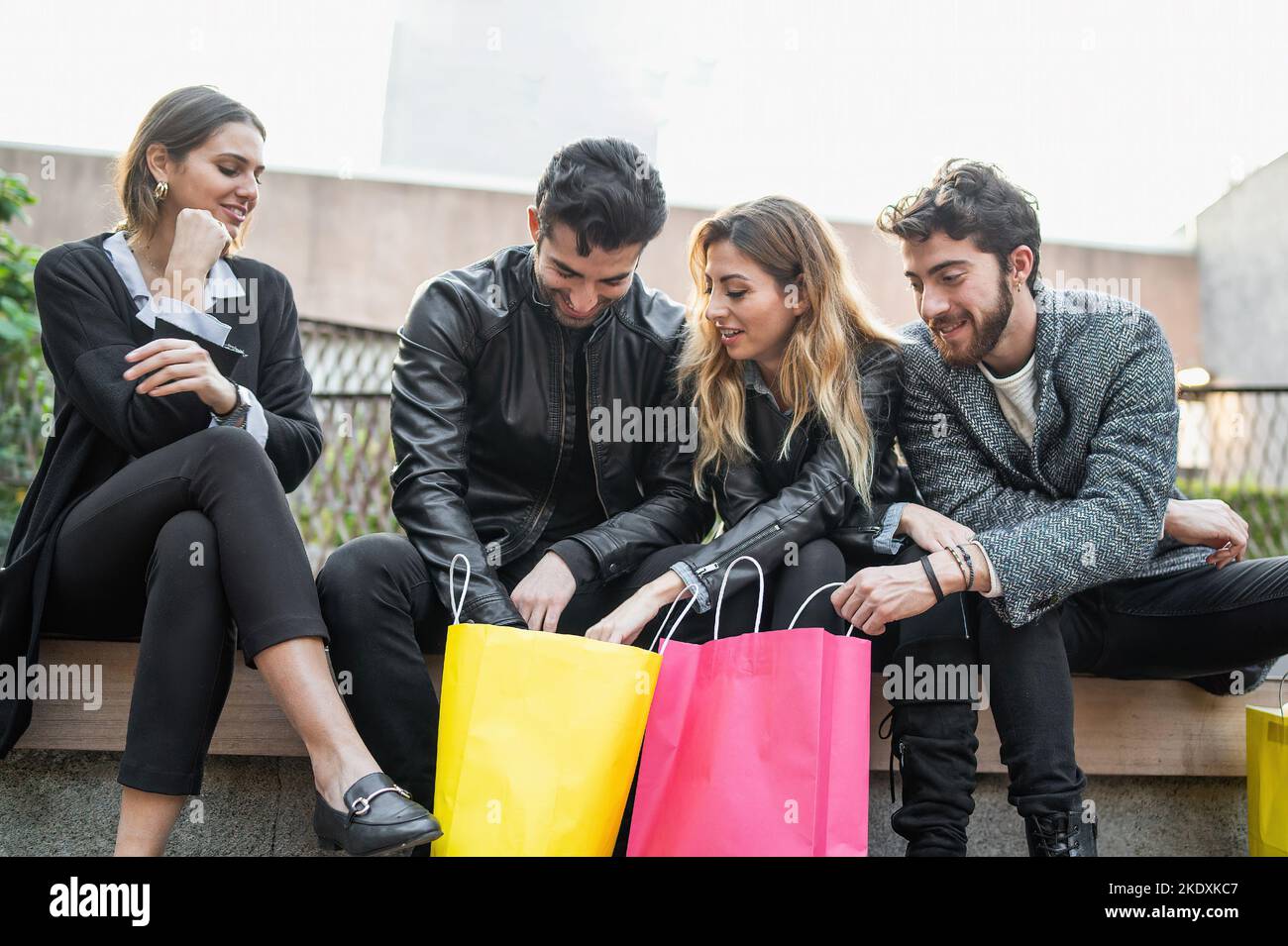 Group of young friends with shopping bags - Portrait of four people ...