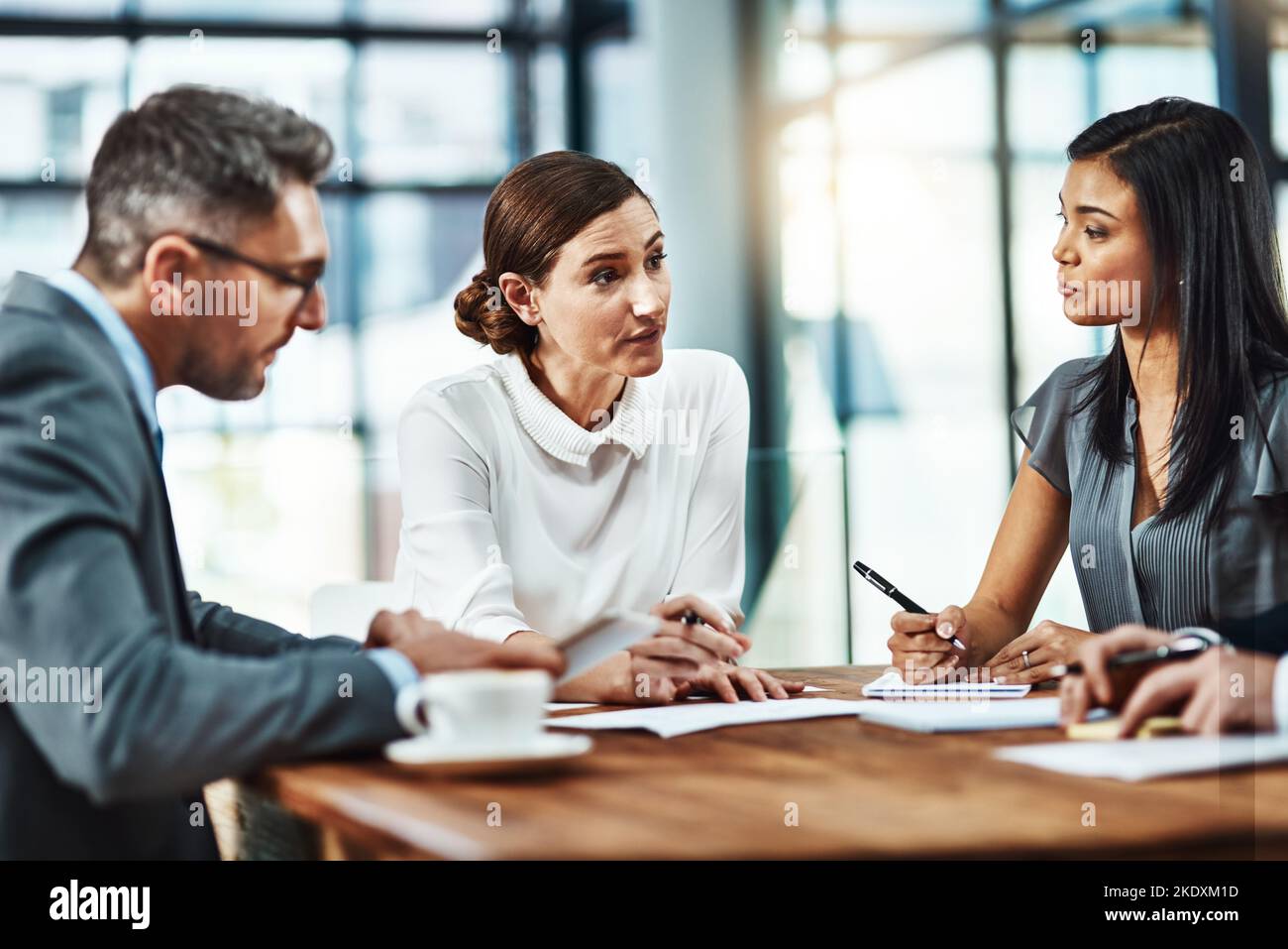 Business talk that makes things happen. a group of colleagues having a ...