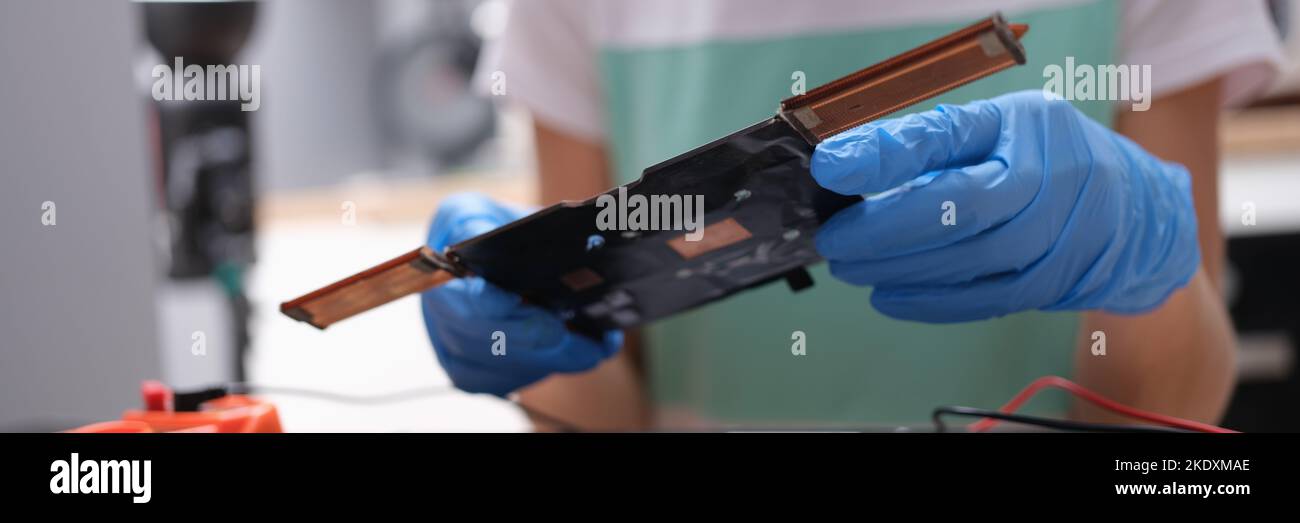 Tech fixes motherboard of laptop in service center Stock Photo - Alamy