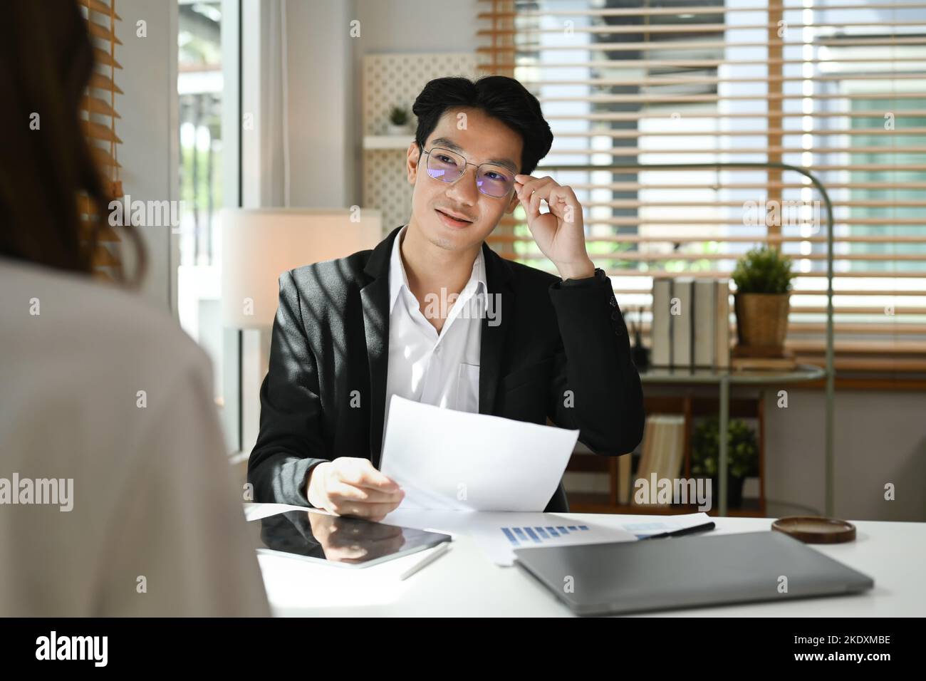 Asian male recruitment manager listening female candidate about her ...