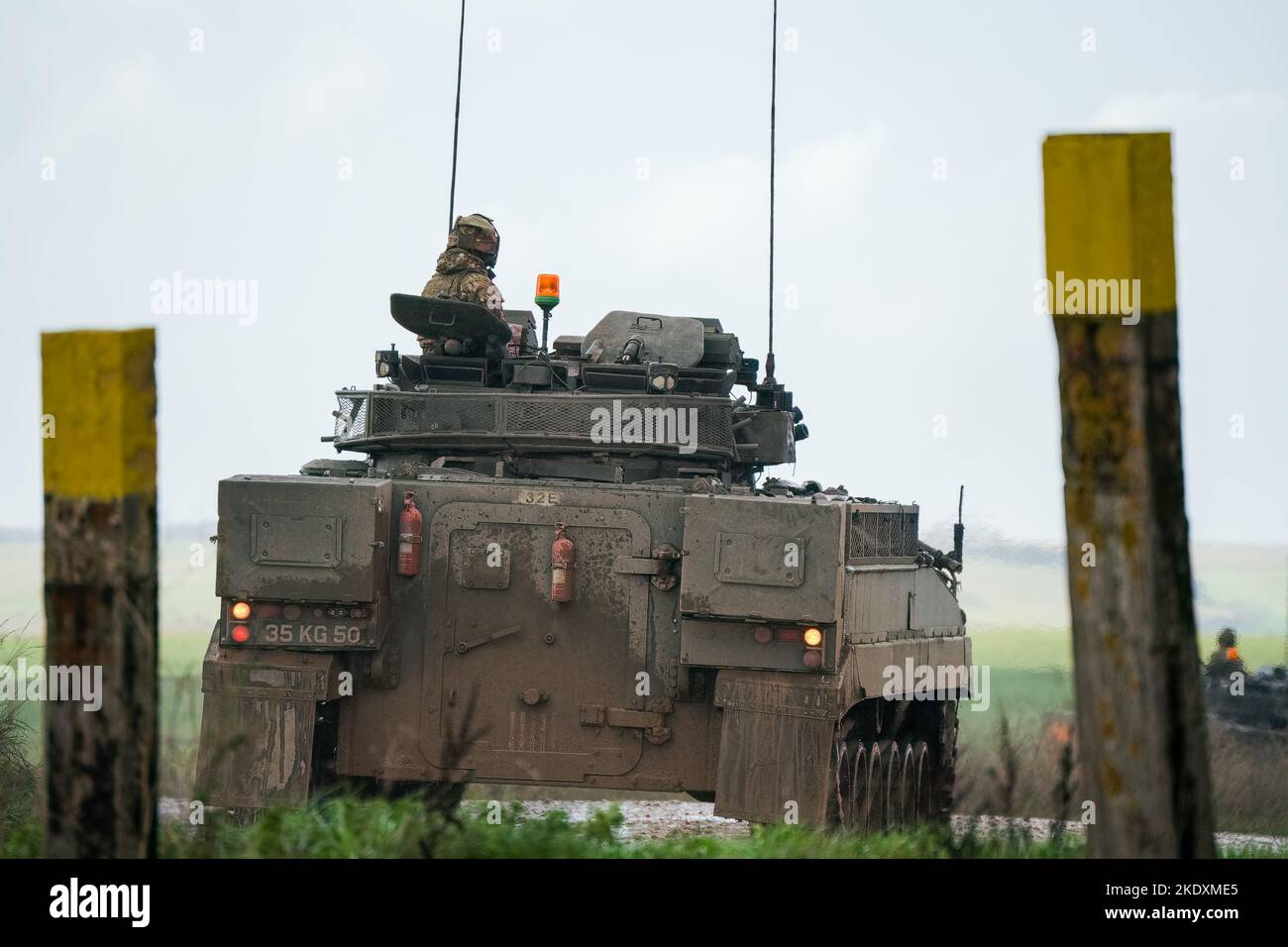 British army Warrior FV510 Fighting Vehicle crossing a sign posted road ...