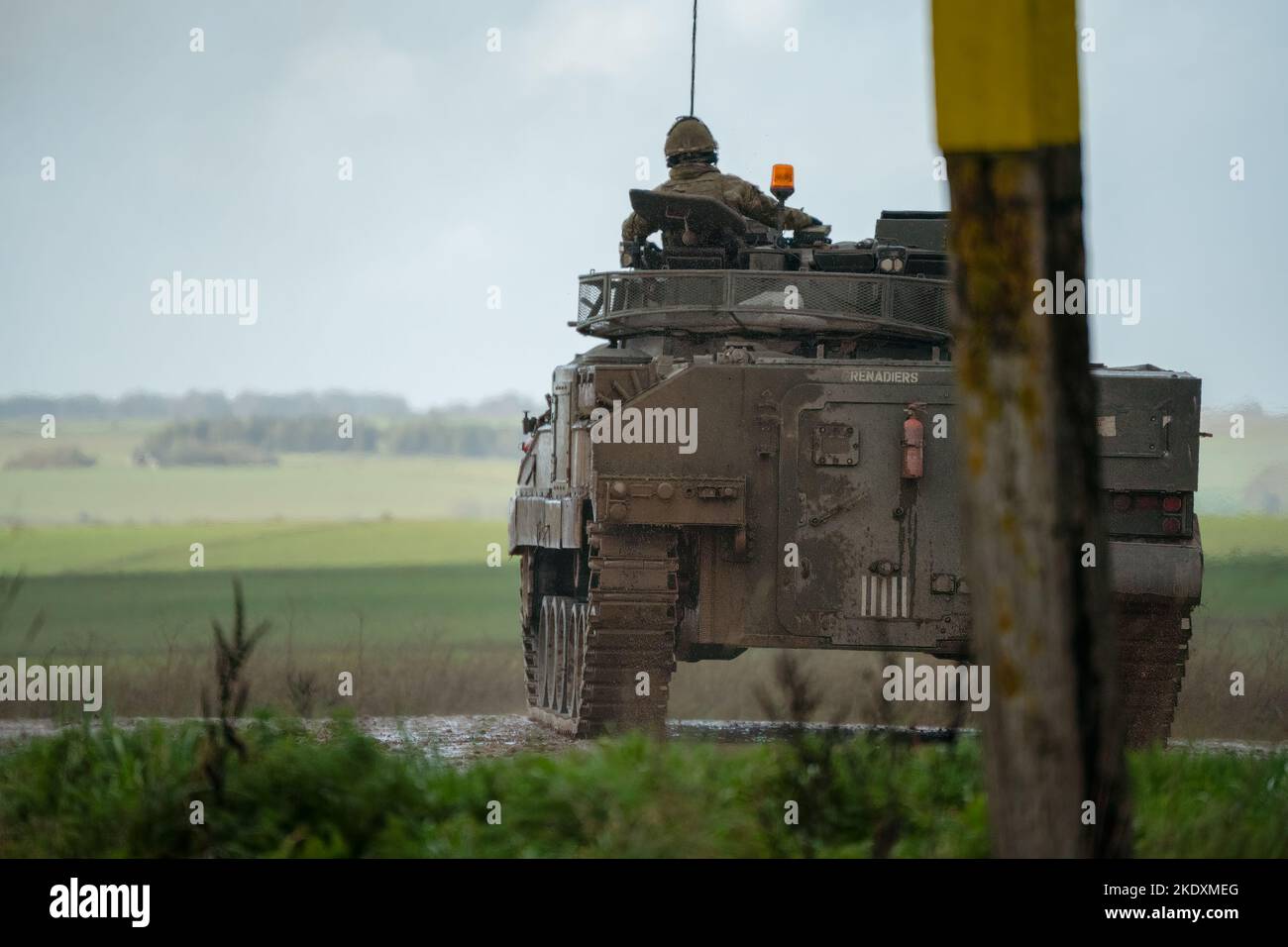 British army Warrior FV510 Fighting Vehicle crossing a sign posted road ...