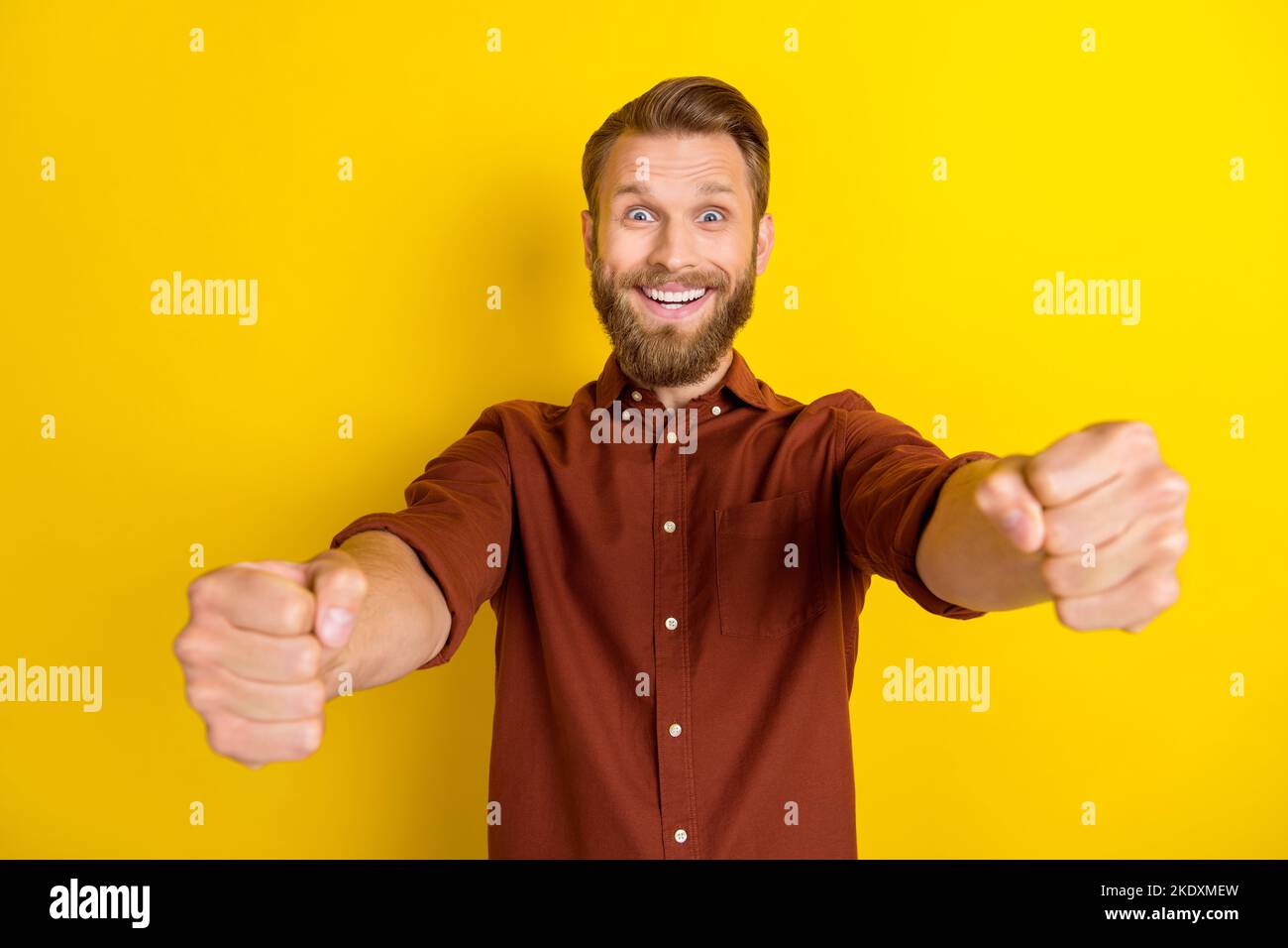 Photo of carefreee crazy man wear nrown stylish clothes hold imaginary ...