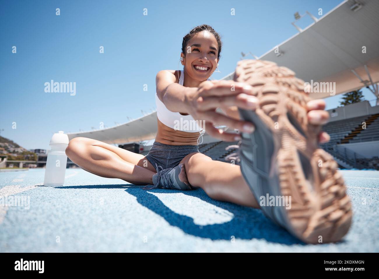Runner, stretch and woman athlete with a smile ready for running ...
