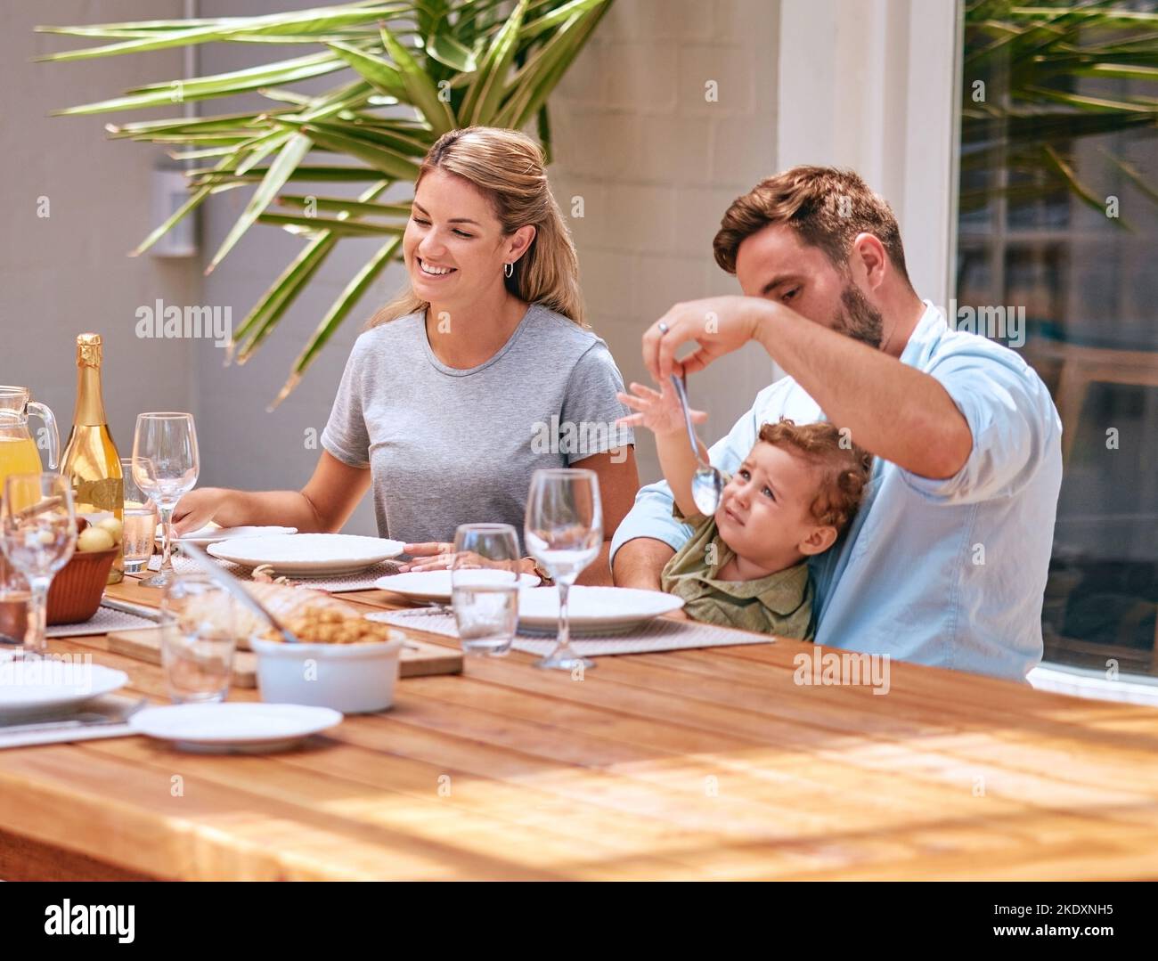 Food, mother and father with baby at table at an outdoor patio for ...