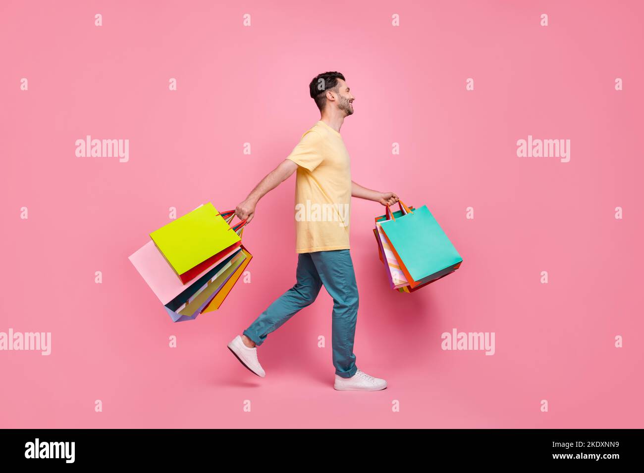 Full length profile side photo of funny cheerful man client customer go ...