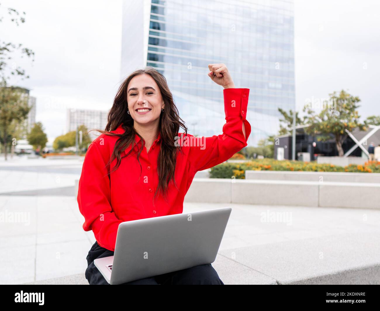 Happy woman in stylish red shirt looking at camera with smile and ...