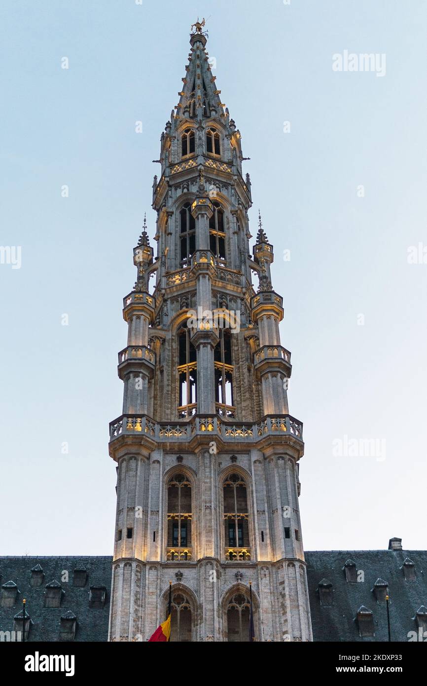 From below view of exterior of Brussels town hall tower with backlight ...