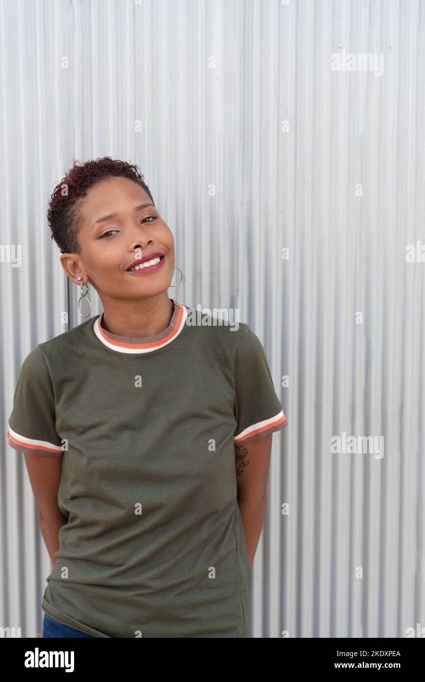 Happy Colombian female in casual clothes with short hair smiling and ...