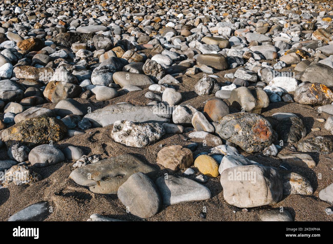 Full frame background of orange pebble located amidst smooth stones on ...