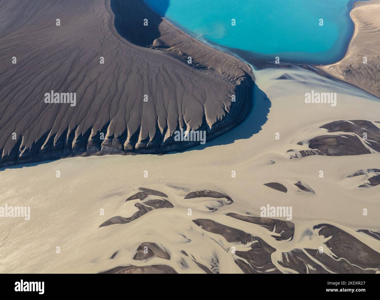 From above drone view of river estuary and tranquil blue lake near rock ...