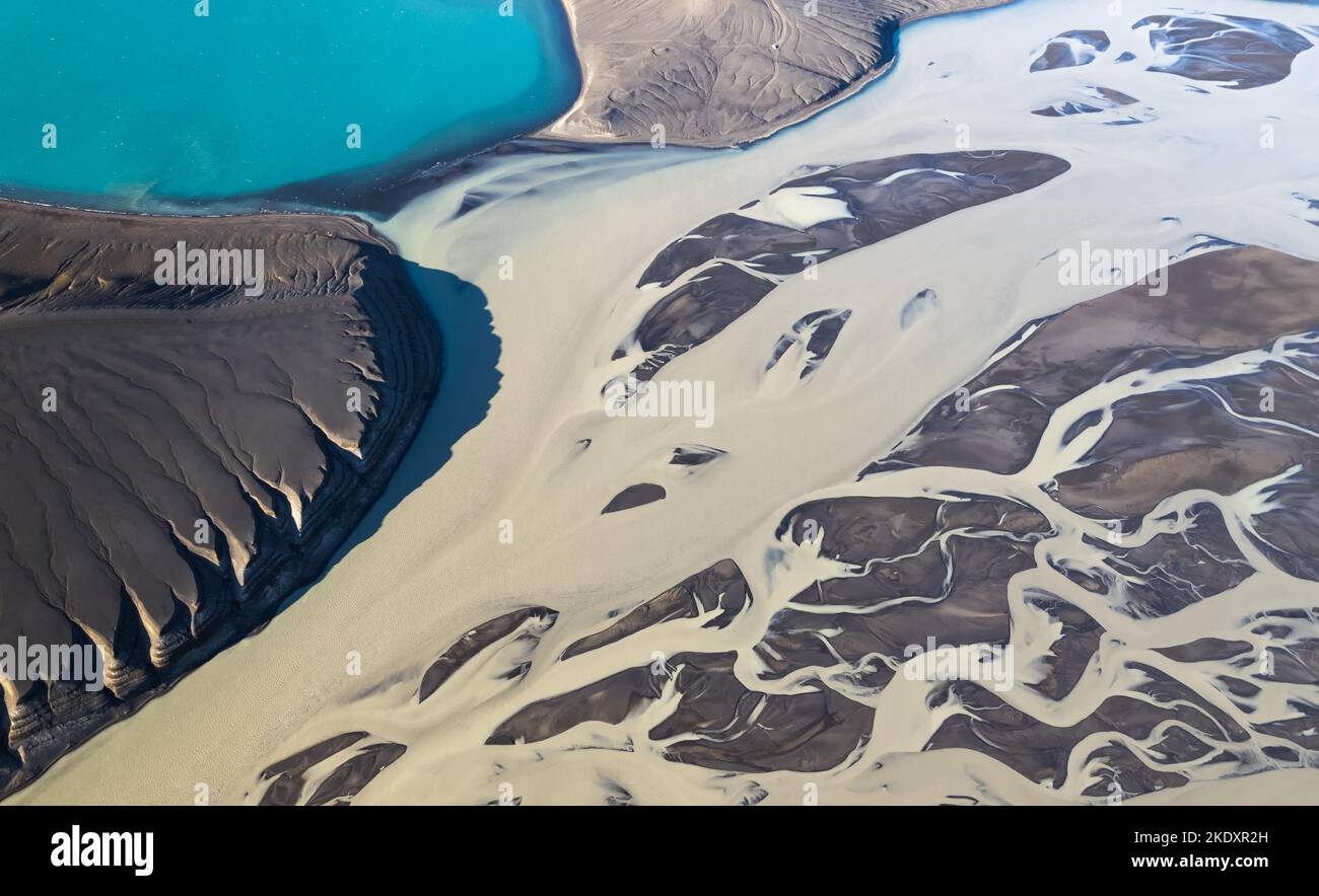 From above drone view of river estuary and tranquil blue lake near rock ...