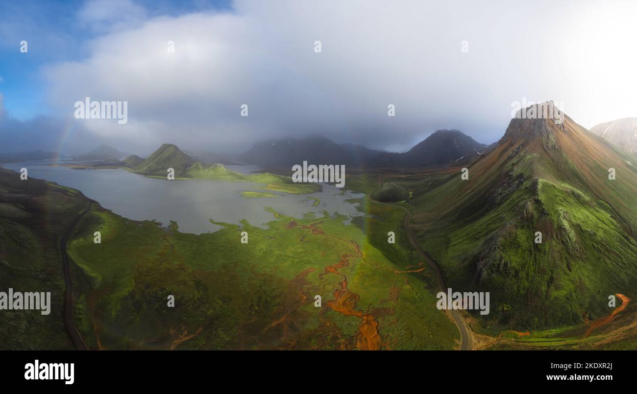 Breathtaking drone view of green mountains and calm lake located in ...