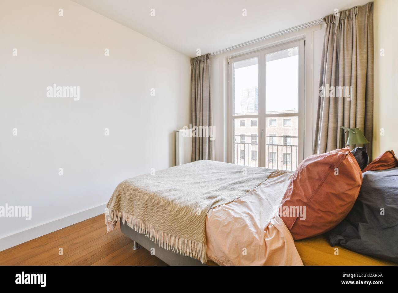 Home interior design of bedroom with bed placed in corner near window ...