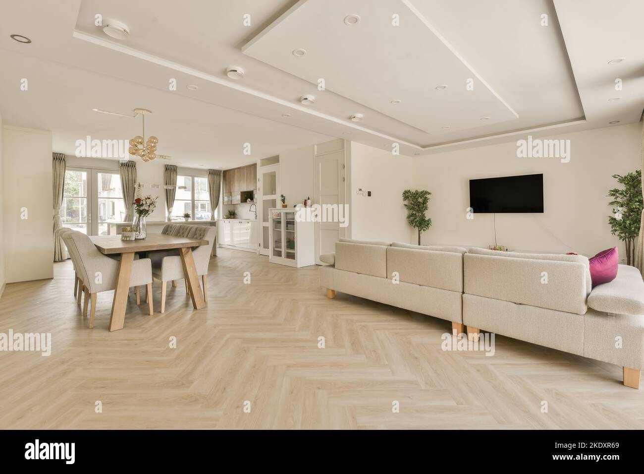 Interior of contemporary open space flat with dining table and sofa in ...