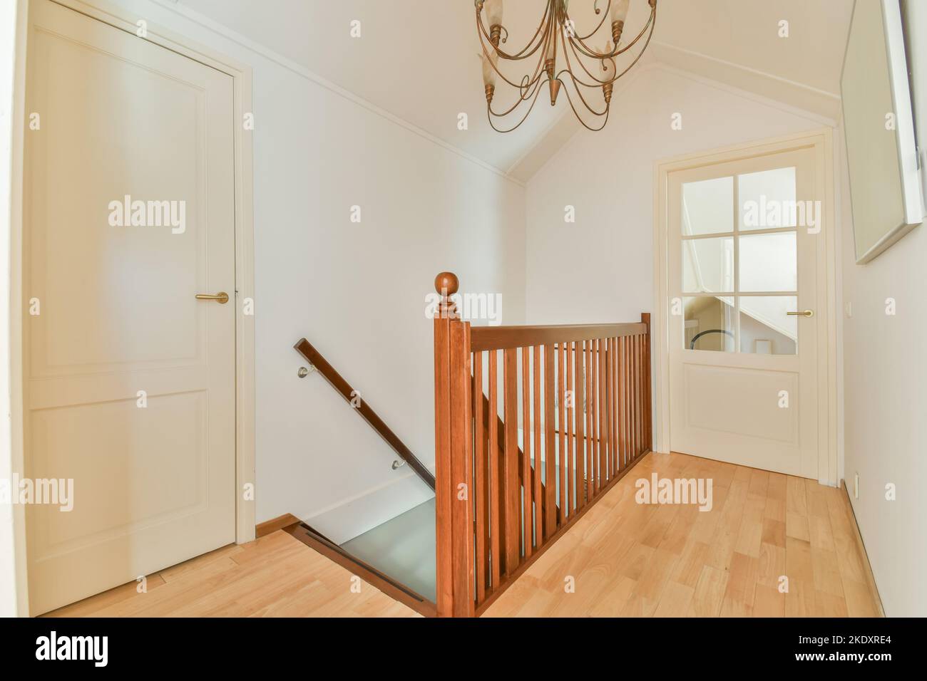 Interior passage way in bright modern house with parquet floor and stairs Stock Photo - Alamy