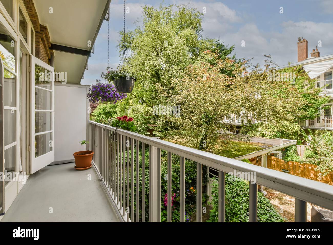Views of multiple houses and backyard from metal balcony under cloudy ...