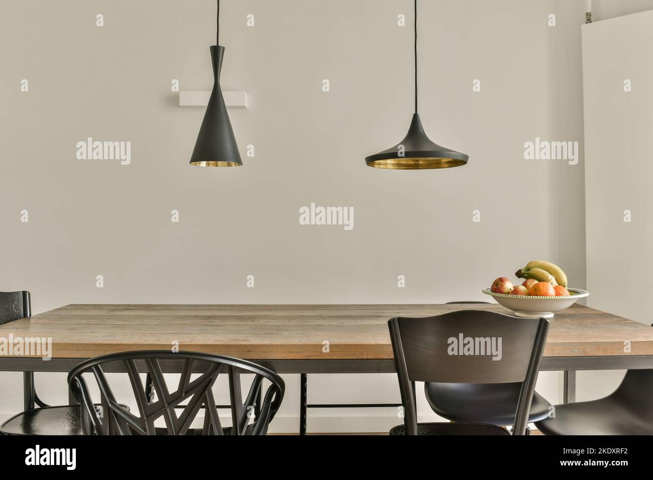 Interior of modern home with table and chairs under two lamps Stock ...