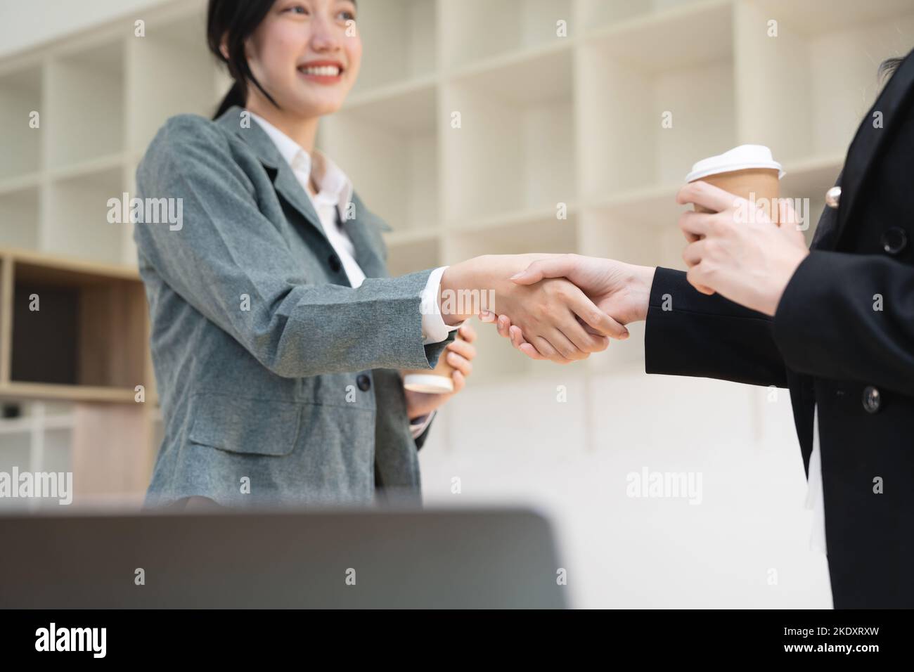 Handshake of businesspeople. Two asian female hand makes a handshake in ...