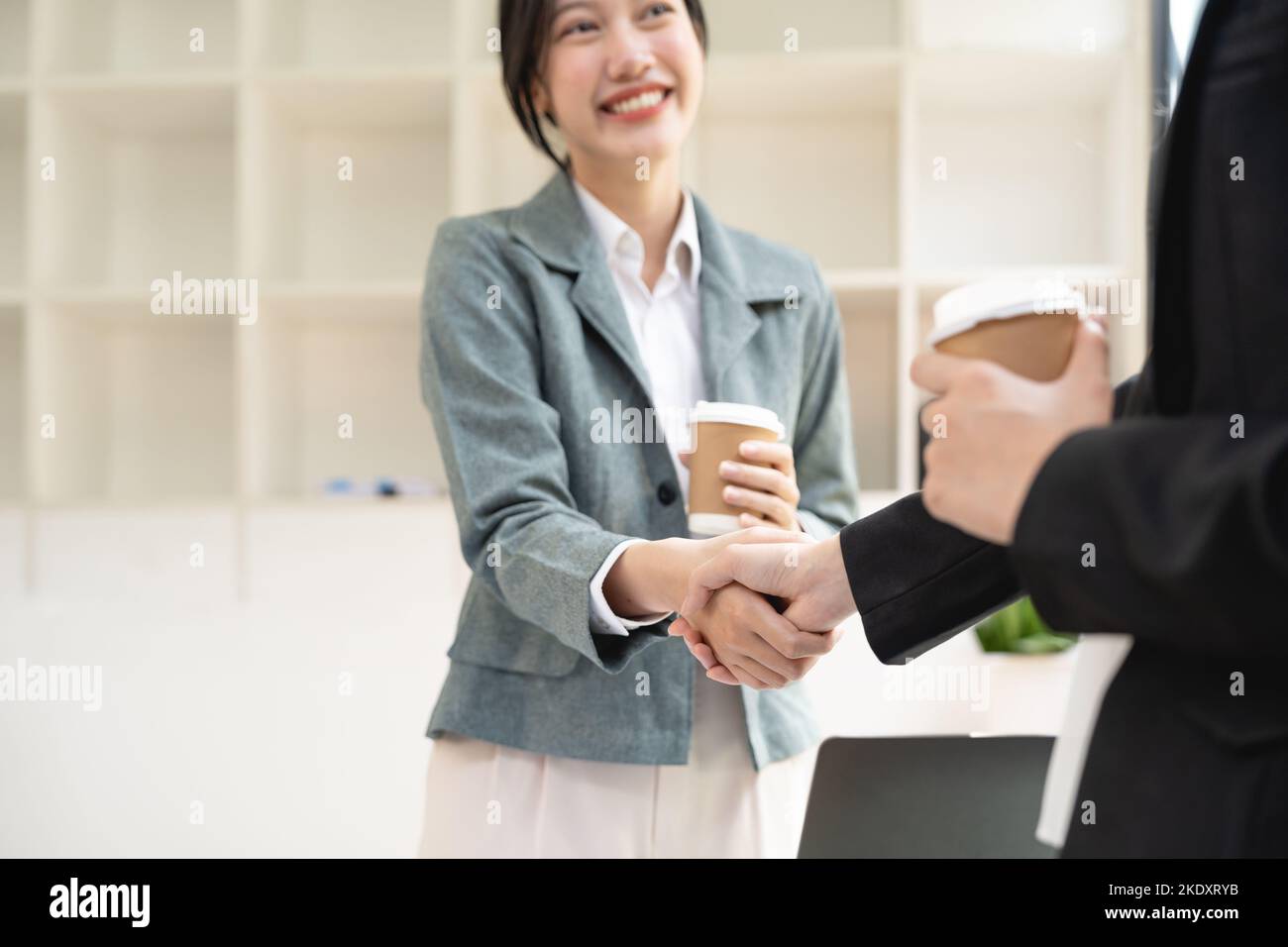 Handshake of businesspeople. Two asian female hand makes a handshake in ...