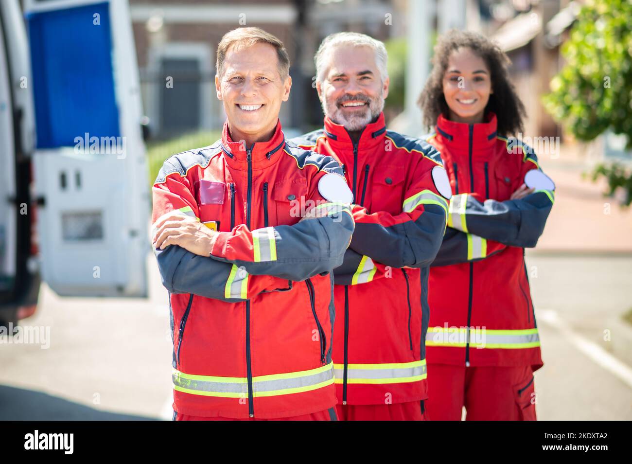 Joyous paramedics in red uniforms ready for their shift Stock Photo - Alamy