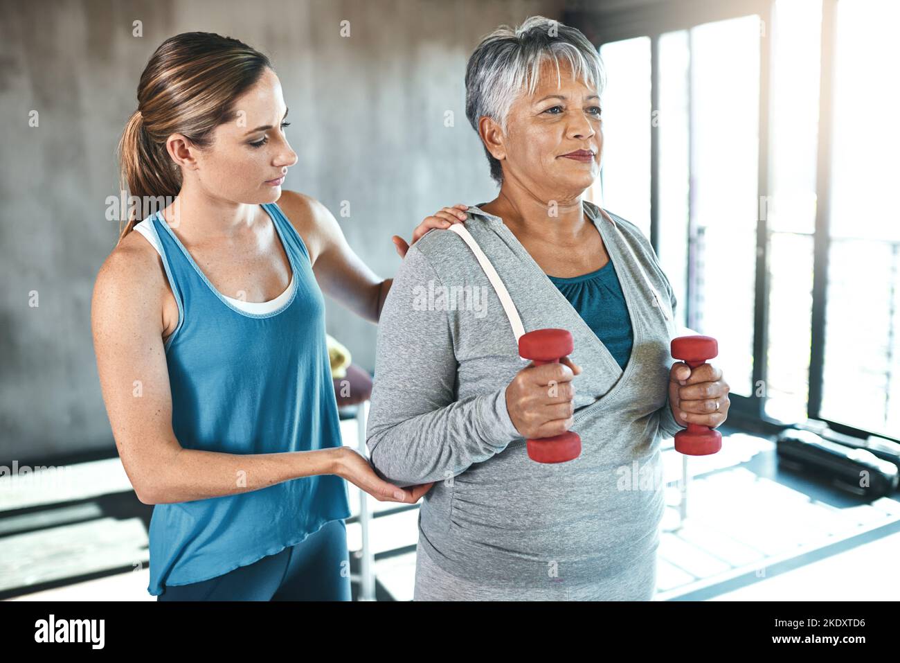 Getting stronger in the golden years. a senior woman using weights with ...