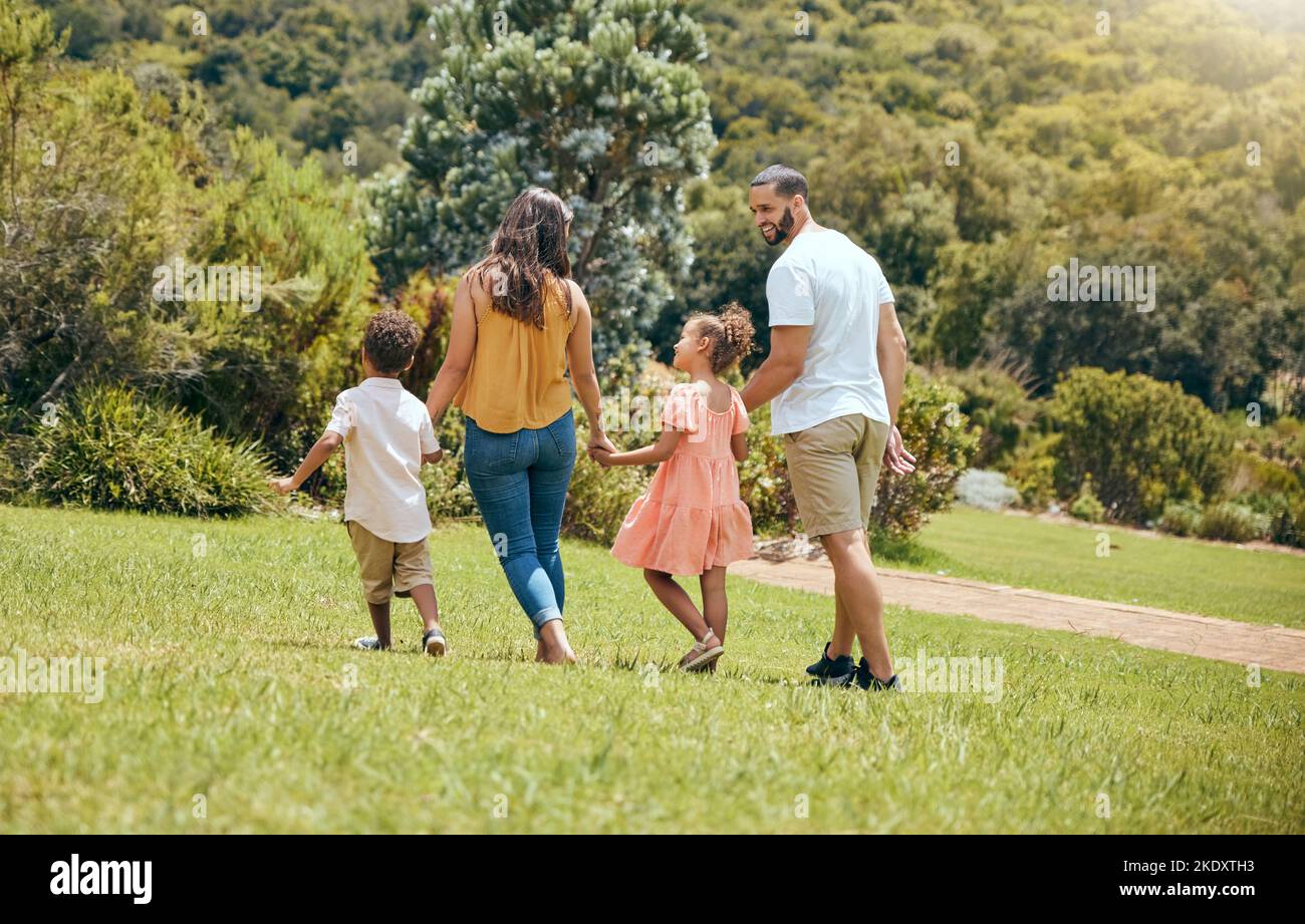Family, kids and walking in the park for bonding, fun and care in ...