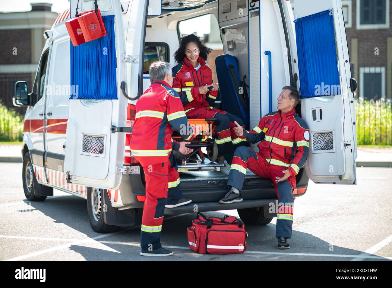 Team of EMS workers discussing something before their shift Stock Photo - Alamy