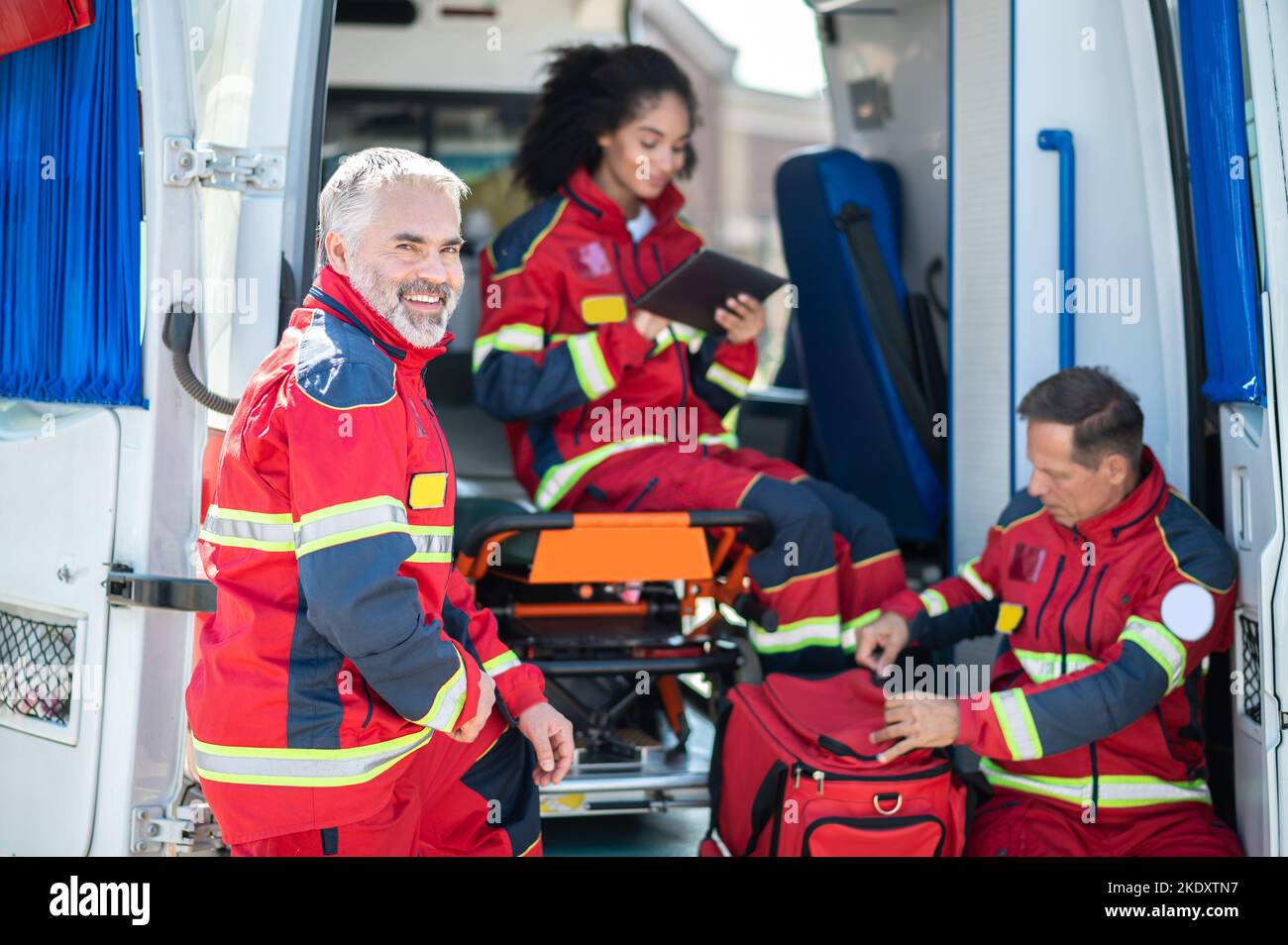 Team of EMS workers getting ready for the shift Stock Photo - Alamy