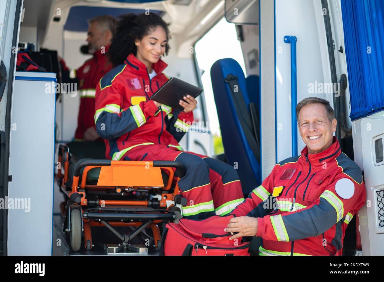 Team of EMS doctors getting ready for work Stock Photo - Alamy