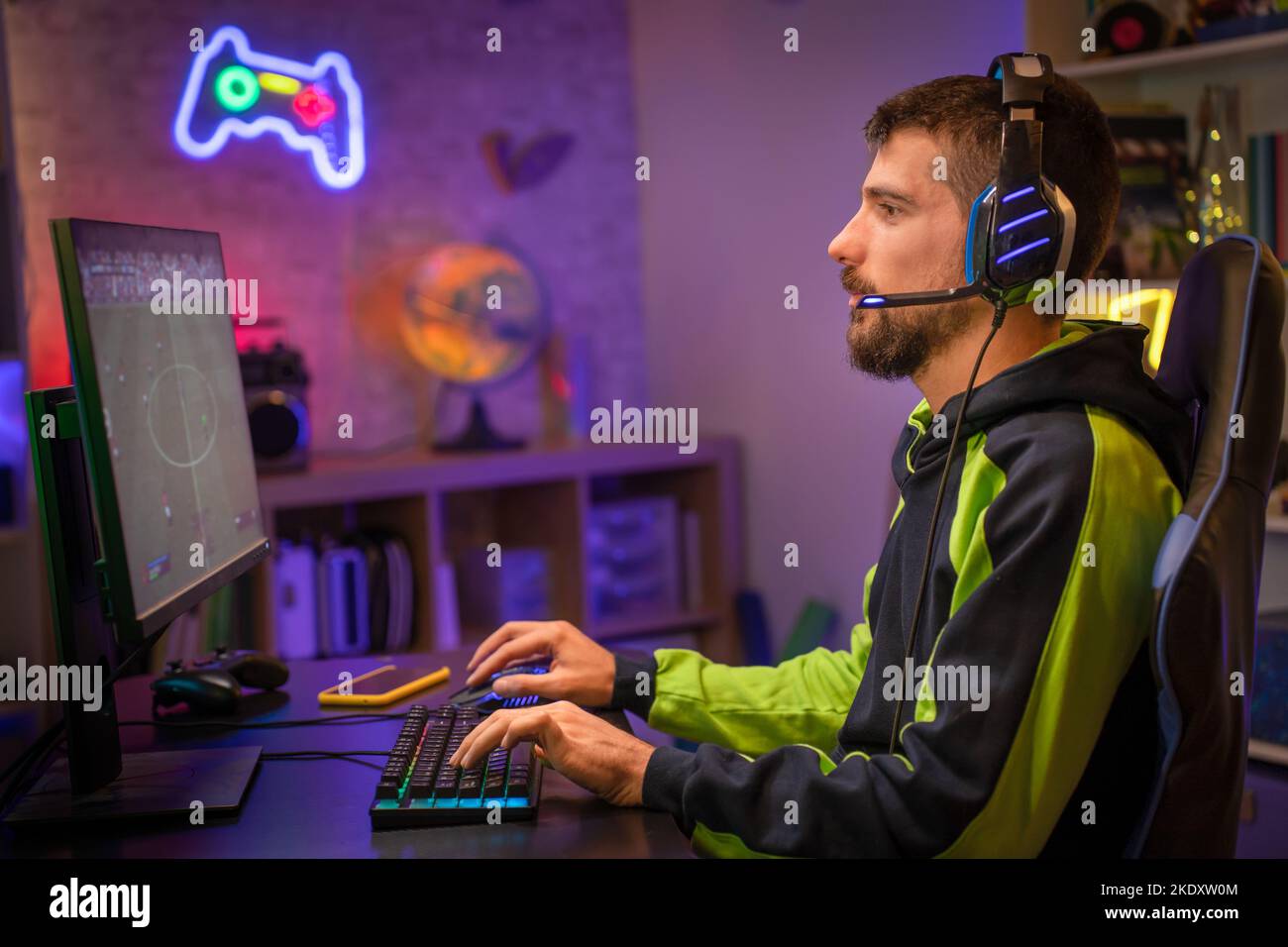 Professional Gamer Playing Online Video Game on Computer with Colorful ...