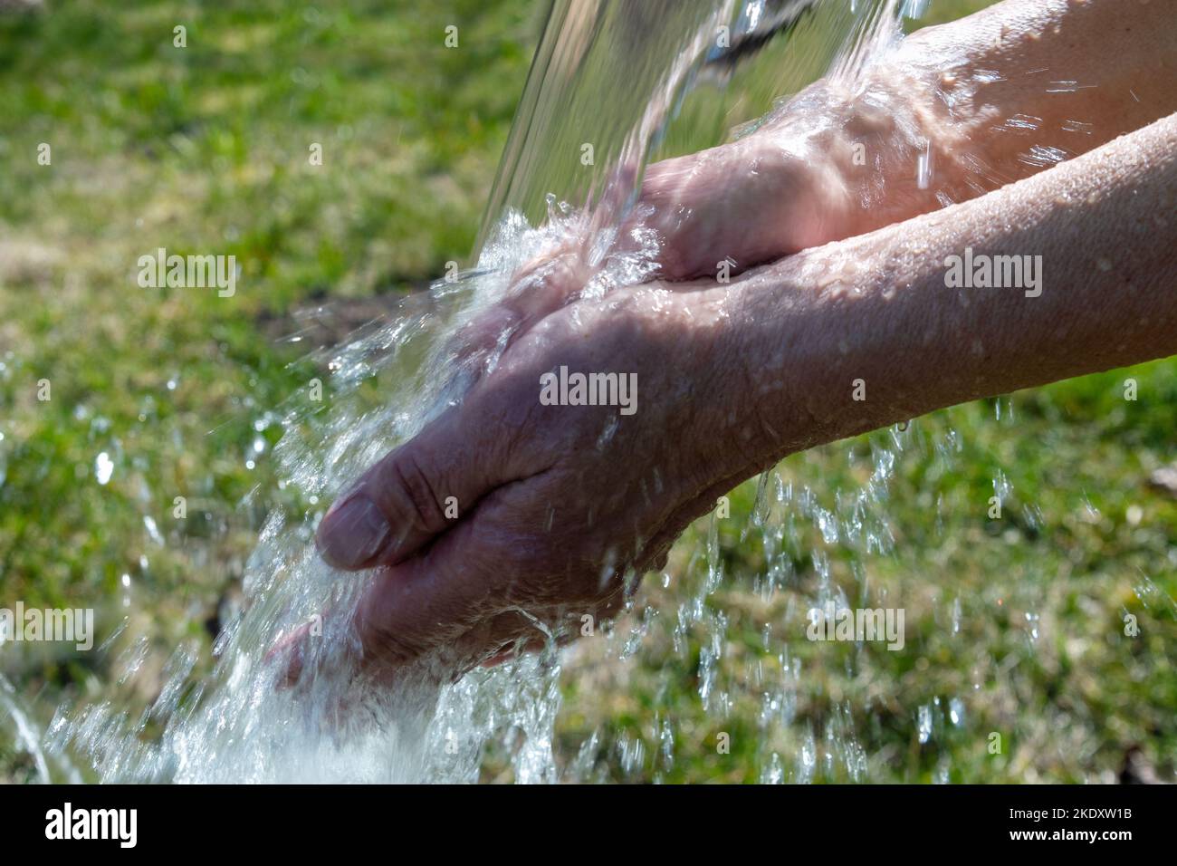 Hand washing by pouring water outdoors Stock Photo - Alamy