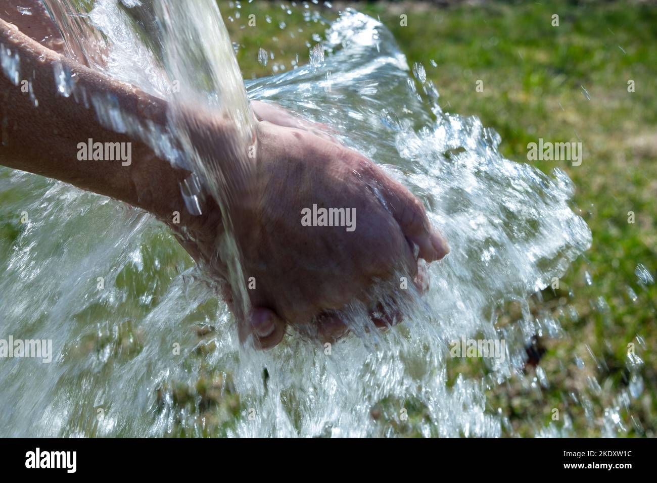 Hand washing by pouring water outdoors Stock Photo - Alamy