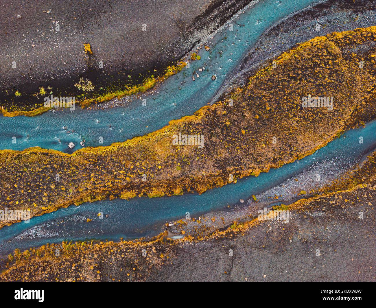 Drone shot river running trough black volcanic sand Stock Photo - Alamy