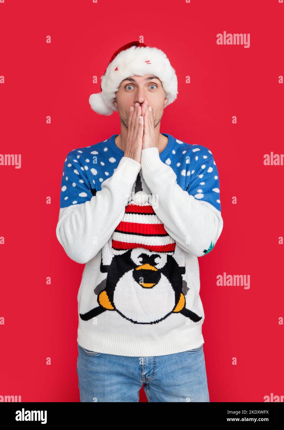 new year mood. shocked man isolated on red background wear new year ...
