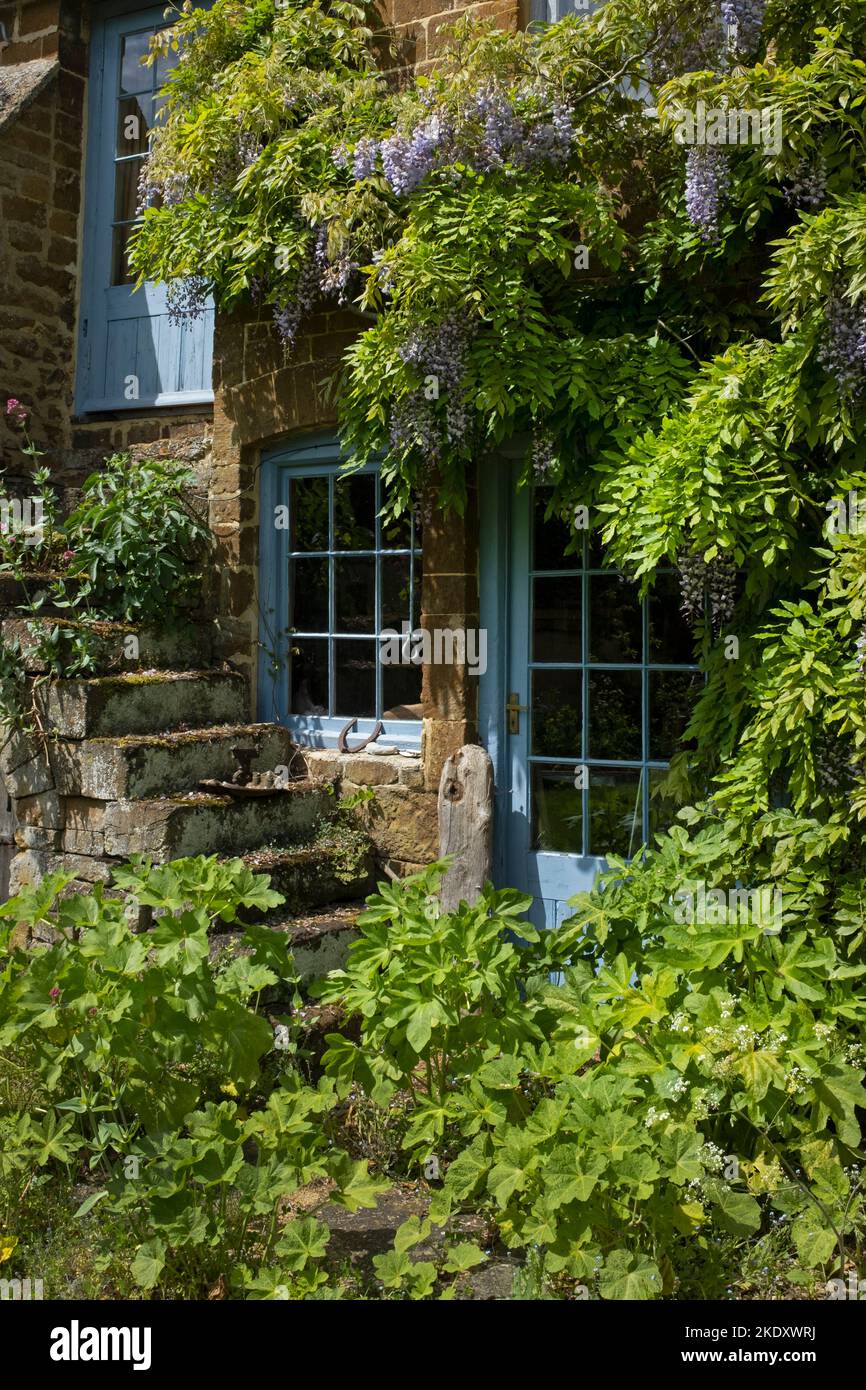 old cotswold cottage with stone exterior steps leading to upper floor ...