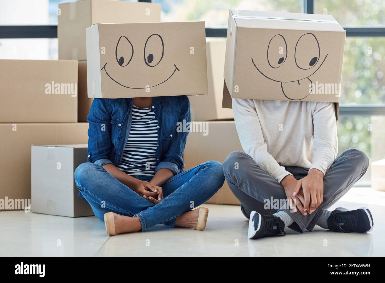 Getting caught up in the packing craze. a fun couple sharing a light ...