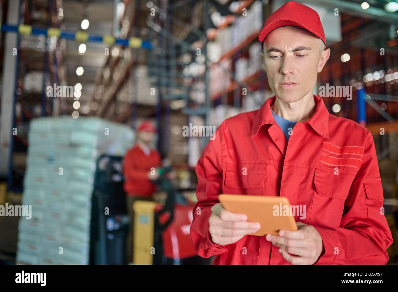 Two men working in the distribution warehouse Stock Photo - Alamy