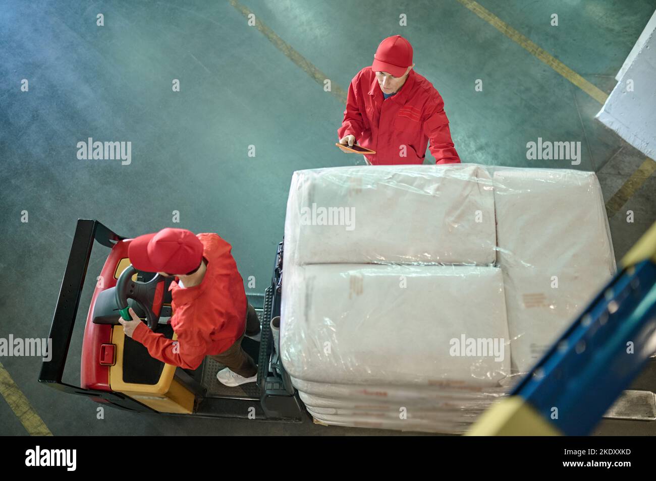 Two storehouse workers preparing freight for shipping Stock Photo - Alamy