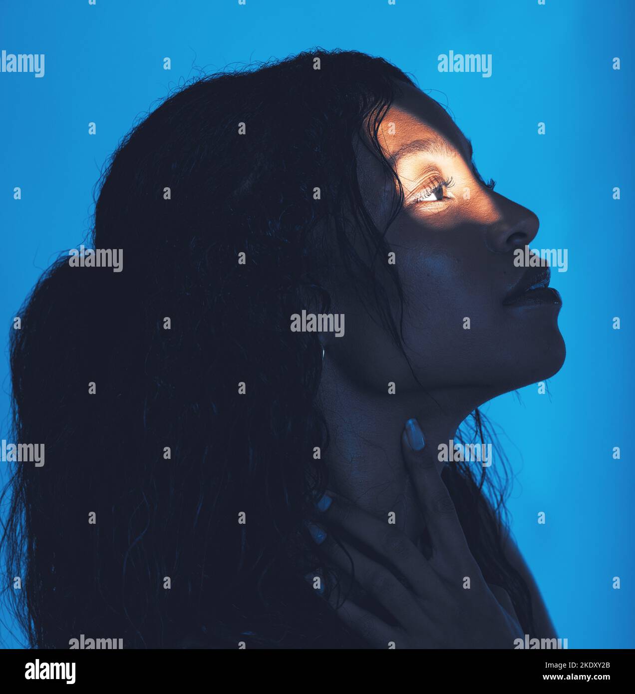 Spotlight, model and woman for skincare, face and cosmetics with blue ...