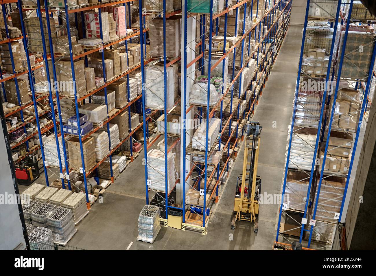 Forklift driver working in a huge storehouse Stock Photo - Alamy