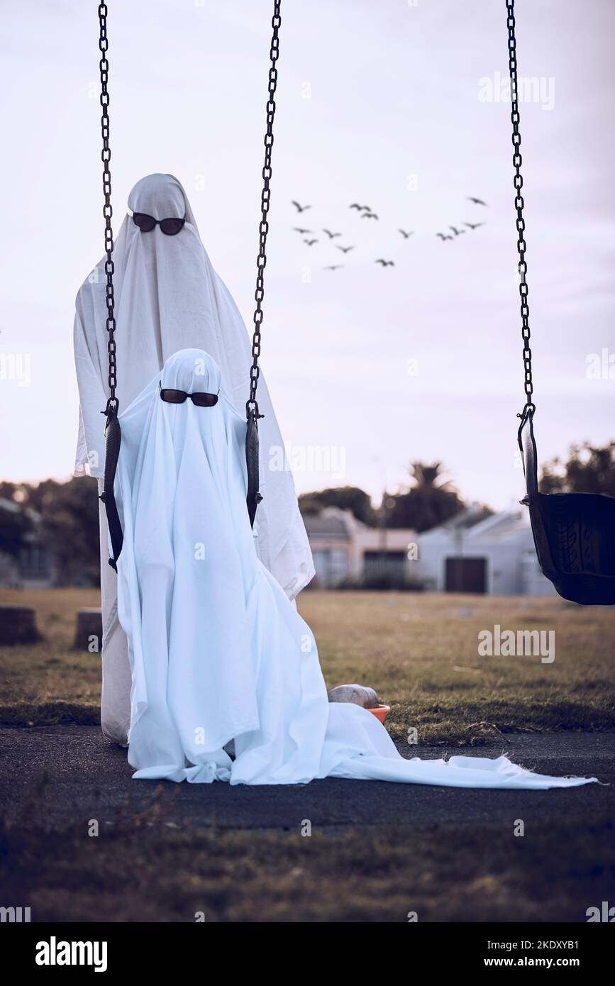 Halloween, ghost costumes and sunglasses in the park for scary family ...