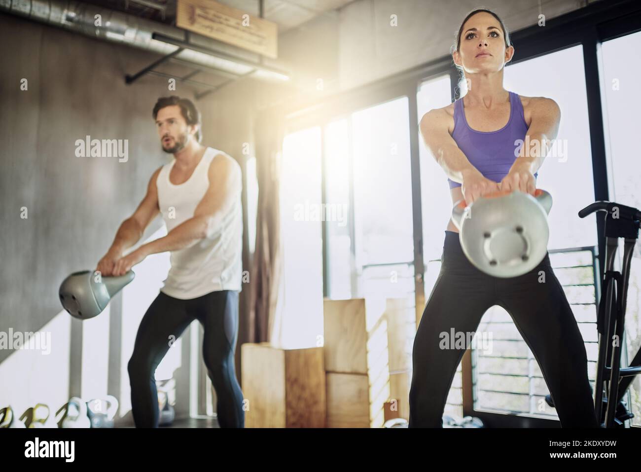 Sometimes a challenge is all you need. two young people working out in ...