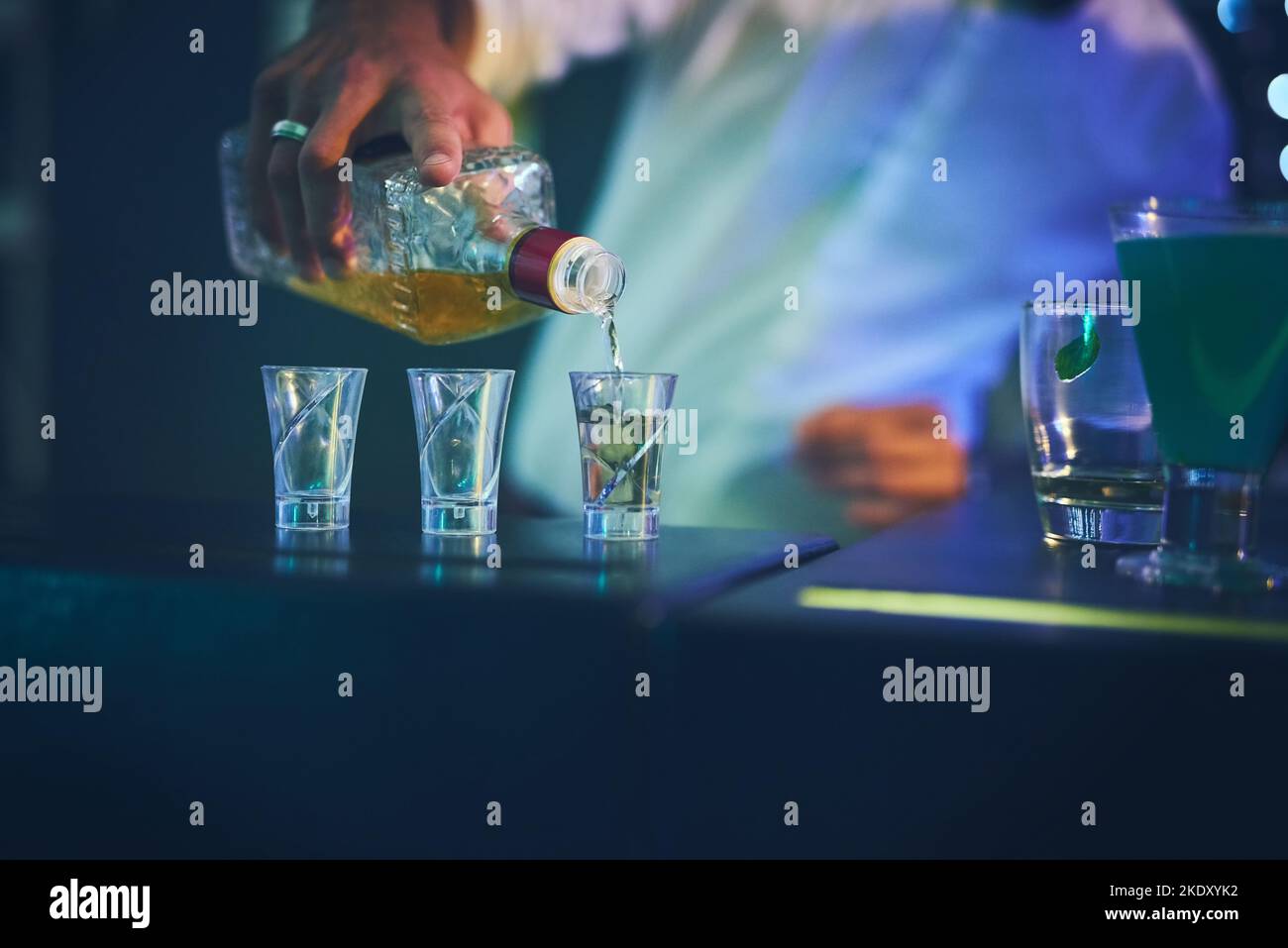 Three more, barman. an unidentifiable barman pouring shots in a ...