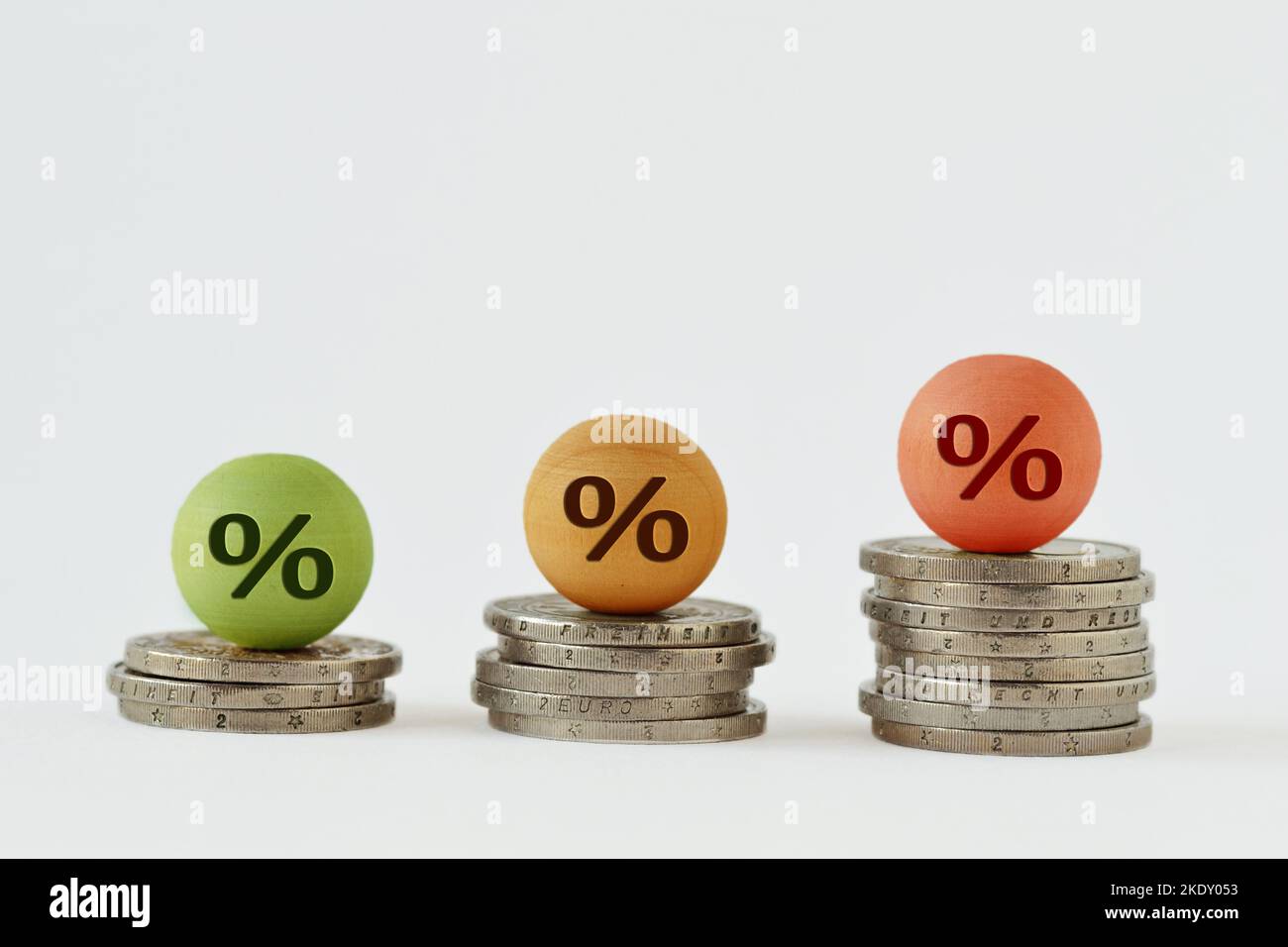 Wooden sphere with percentage symbol on coin stack - Concept of finance ...