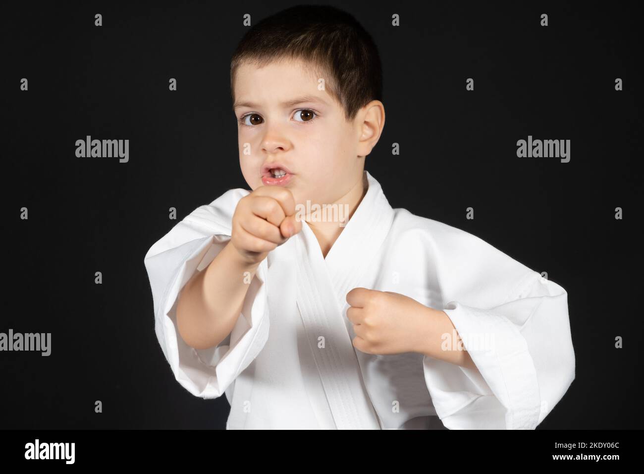 A little boy practices martial arts, karate classes in kimono on a ...