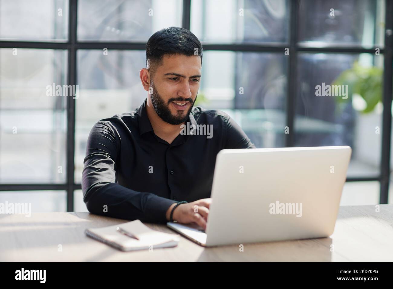 Bearded young businessman working on modern office. Consultant man ...
